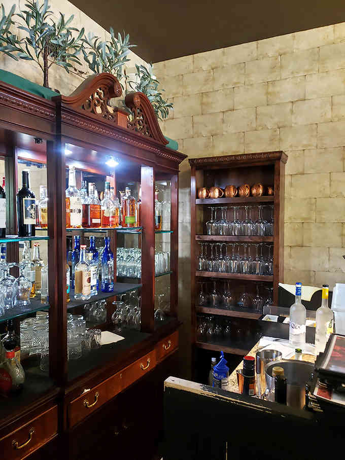 An elegant bar area stocked with spirits and glassware shows this Victorian home means serious business about hospitality.