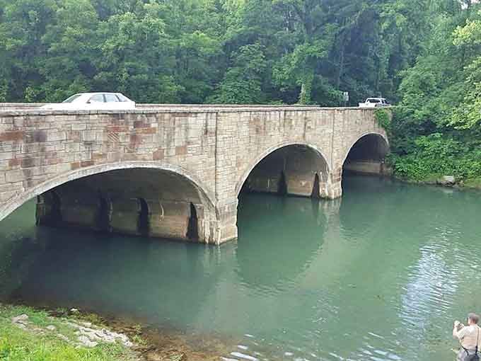 Hand-laid stone arches spanning spring water like something from a European postcard, except this one's in your backyard.