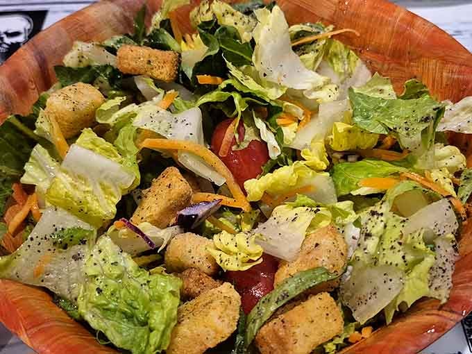 Even the salad gets respect here, loaded with fresh vegetables and croutons for those seeking lighter fare options.