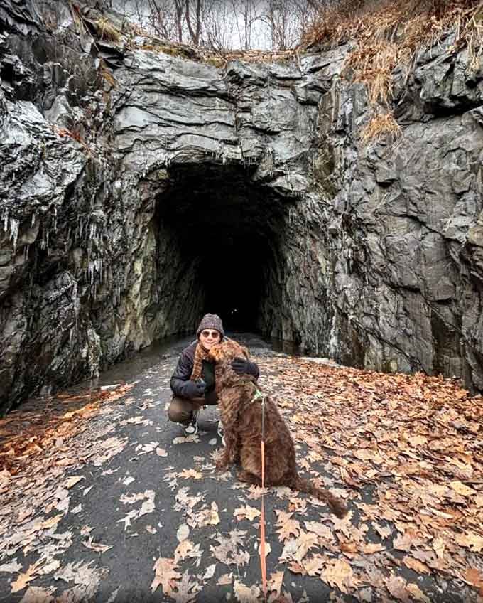 Four-legged hiking companions love this trail too, especially when autumn leaves crunch underfoot near the mysterious tunnel entrance.