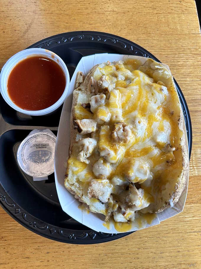 A baked potato loaded with chicken and melted cheese becomes a complete meal in edible packaging.