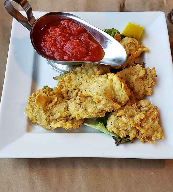 Fried oysters resting on greens with that vibrant red sauce prove that sometimes the South does seafood better than anywhere else.