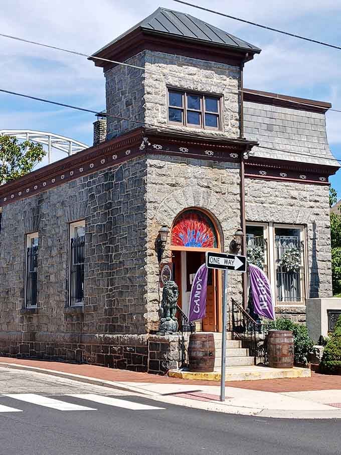 Stone architecture meets whimsical purple banners at this corner building that clearly refuses to take itself too seriously.