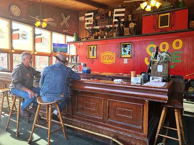 The bar counter where locals gather, proving that good company makes every meal taste even better.