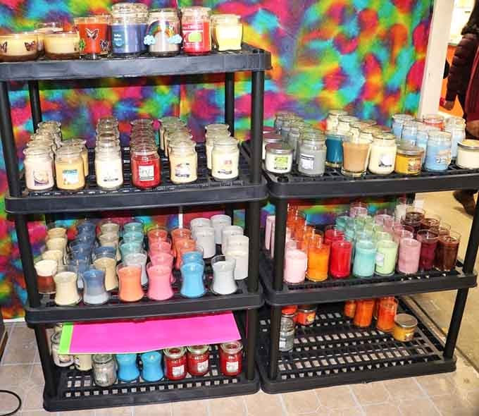 Rows of scented candles in every color imaginable, because apparently choosing a fragrance requires this many options. We're not complaining.