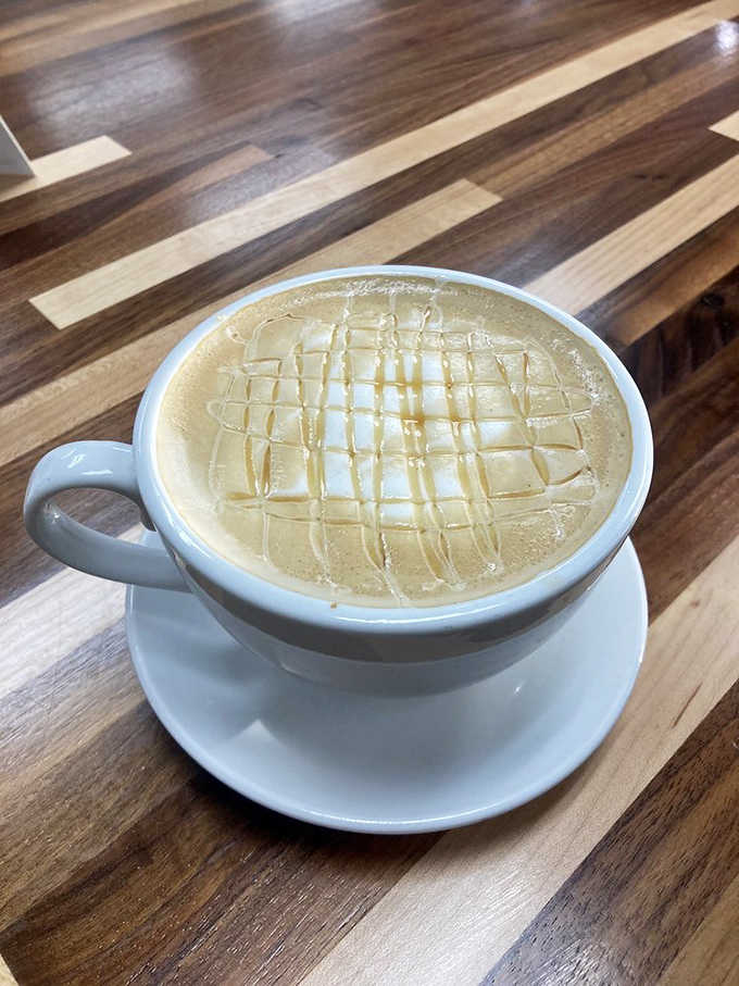 Caramel drizzle on foam-topped coffee art, because even your caffeine fix deserves to look Instagram-worthy at Crepella.