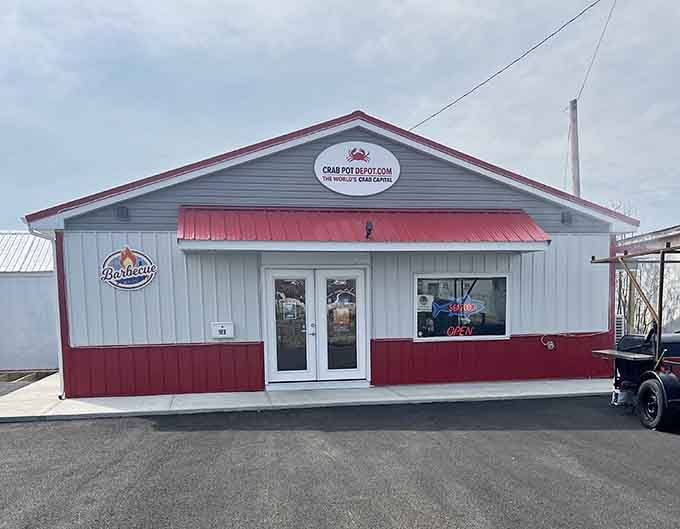 The Crab Pot Depot's red and white exterior signals serious seafood business, where the bay's bounty gets processed and shipped daily.