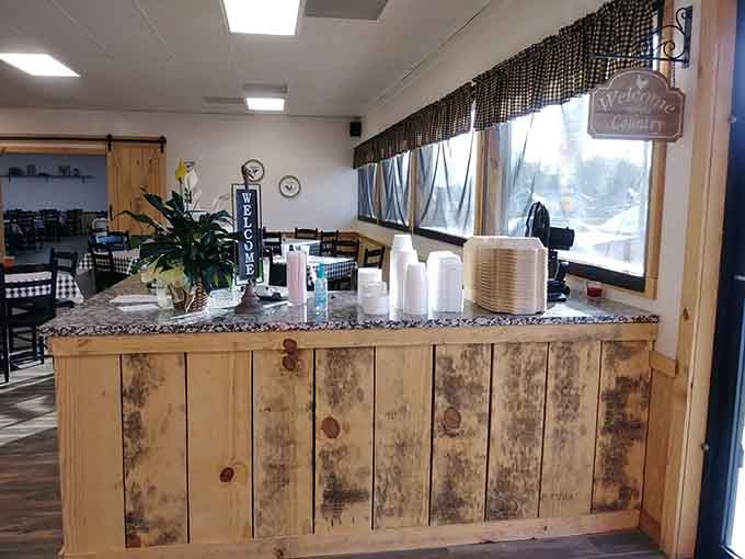 The rustic service counter welcomes you in with stacks of plates, ready for your culinary adventure to begin.