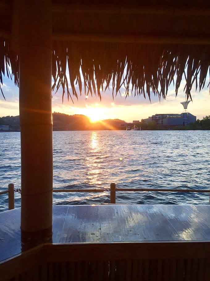 Sunset through the tiki roof hits different when you're floating on the river with nowhere else to be.