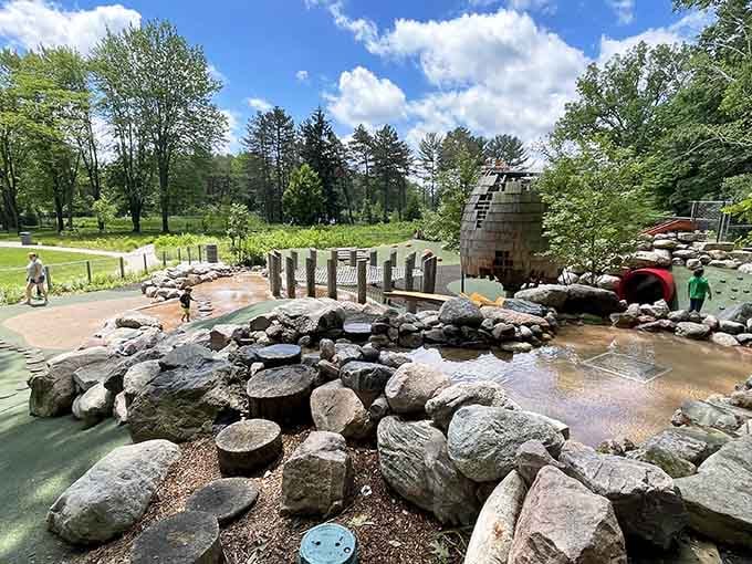 The interactive water playground lets kids splash around while parents enjoy watching from nearby shaded benches.