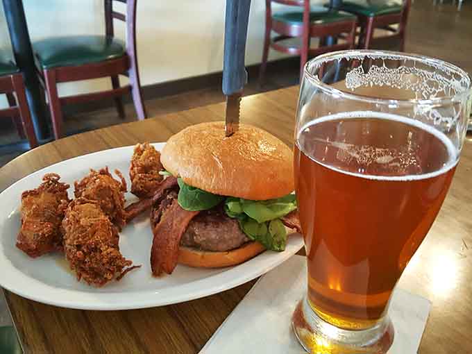Juicy burger with crispy bacon and golden fried pickles paired with local beer makes lunchtime feel like a celebration.