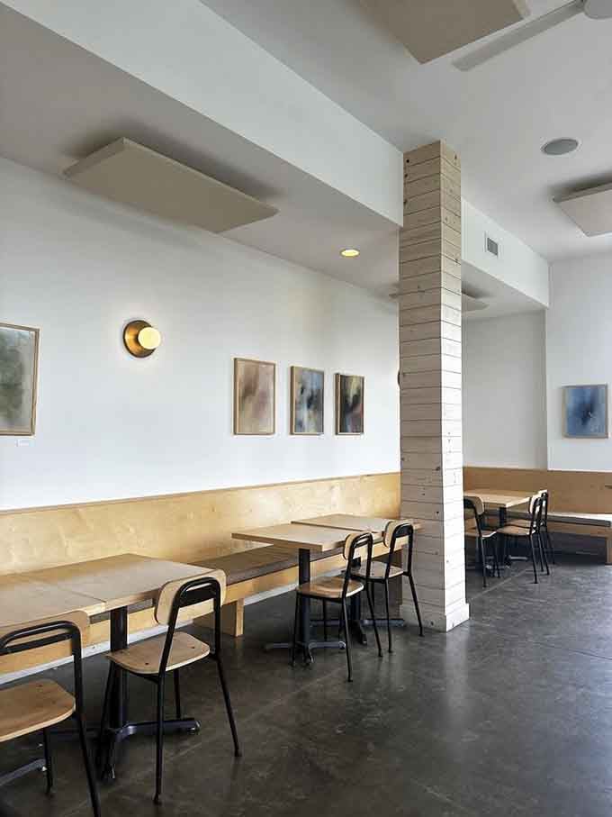 Simple wooden tables and booth seating create a relaxed atmosphere where the food remains the undisputed star of every meal.