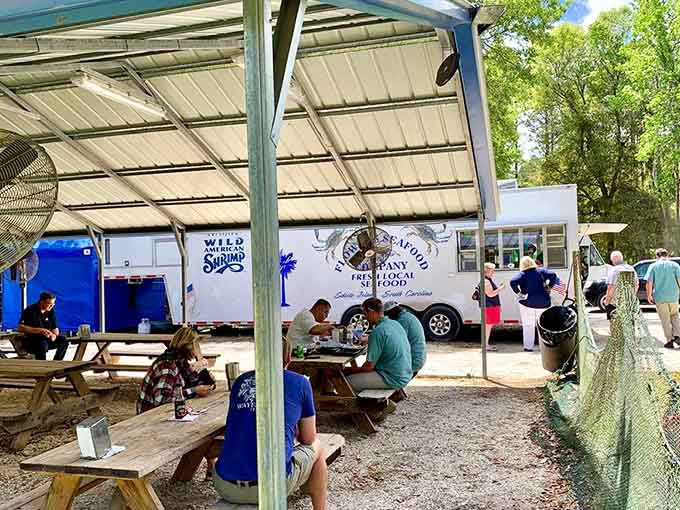 Happy diners enjoying their meals under the pavilion prove that great food needs nothing fancy, just quality ingredients.