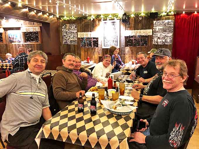 Happy diners gathered around checkered tables, united by their love of exceptional cheesesteaks and good company.