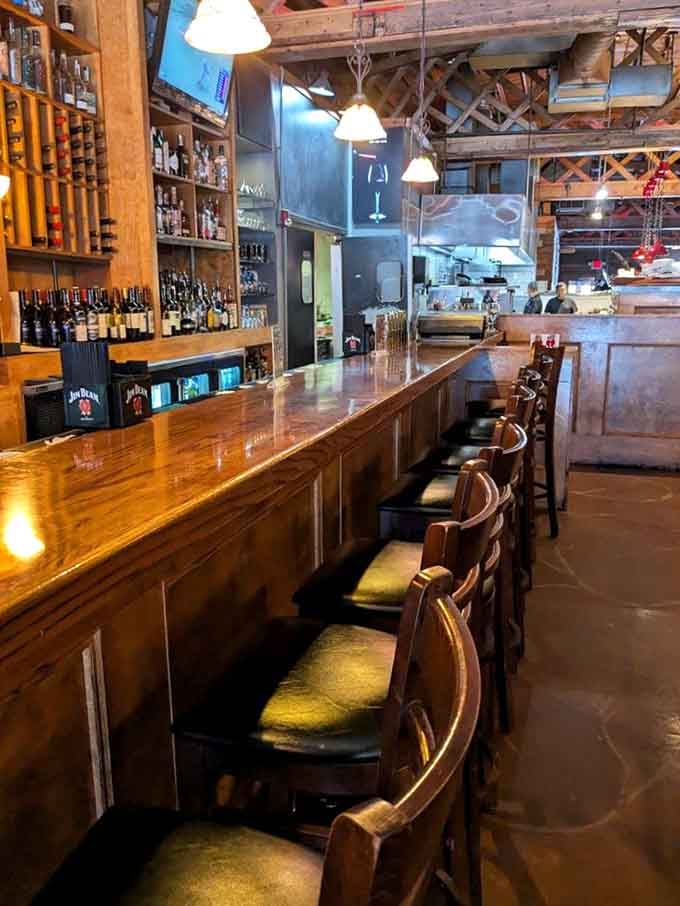 A well-stocked bar with wine displays and comfortable seating invites you to start your evening right.