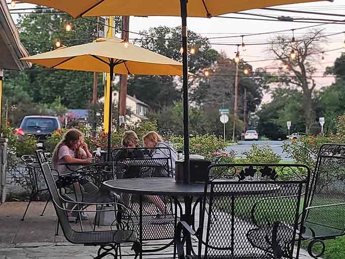 Outdoor seating under umbrellas where you can enjoy your meal while watching the world go by, chicken in hand.