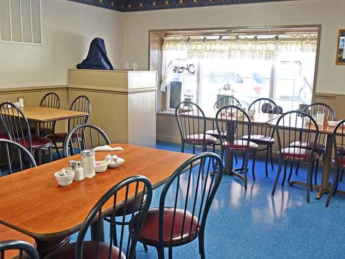 Window-side seating with blue floors offers prime people-watching while you tackle that generous seafood order.