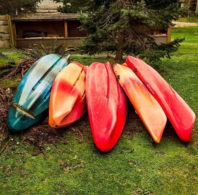 Colorful kayaks stacked and ready prove that water adventures here come in every shade of the rainbow you prefer.
