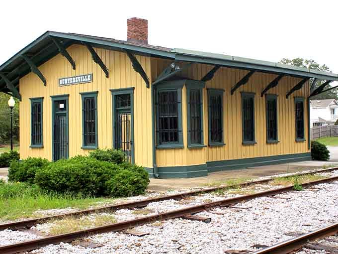 The historic train depot sits preserved in cheerful yellow, reminding visitors that Guntersville's story goes back further than yesterday's catch.