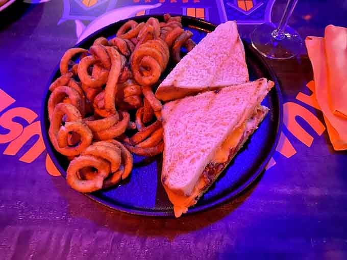 The Grim Reaper Grilled Cheese comes with a mountain of curly fries, proving comfort food doesn't need complicated names.