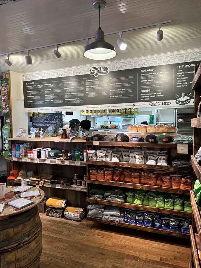 The order counter displays merchandise alongside menu boards, turning sandwich shopping into a full retail experience.