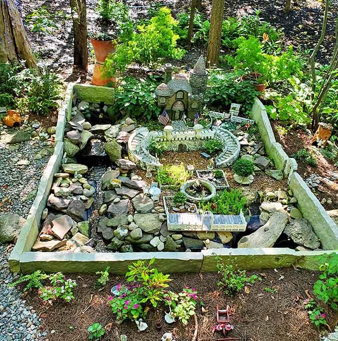 A meticulously crafted fairy garden complete with tiny castle proves that magic comes in all sizes, especially the miniature kind.
