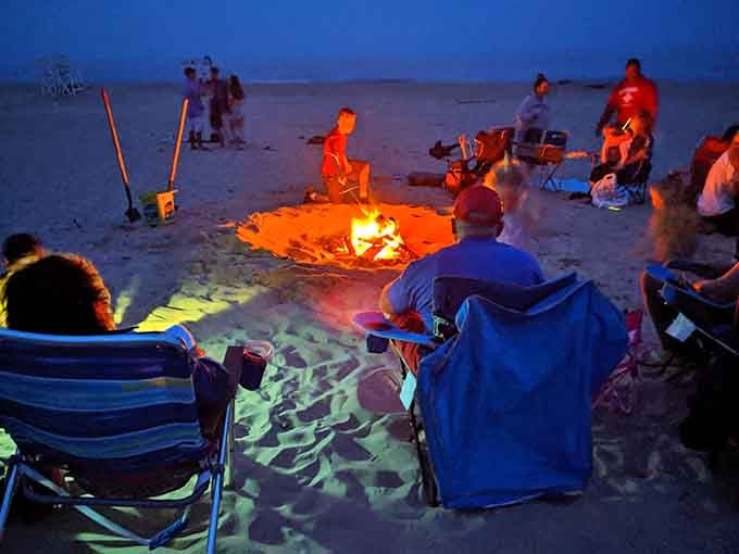 Beach bonfires creating memories that'll outlast any vacation photos gathering digital dust on your phone's camera roll.