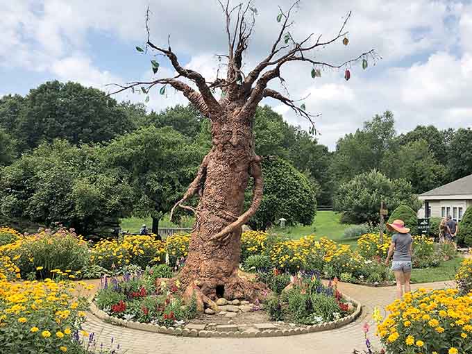 That whimsical tree sculpture surrounded by golden blooms proves nature centers know how to have a little fun too.