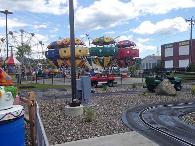 Spinning teacups and colorful umbrellas create a whirlwind of laughter that echoes across the entire park grounds.