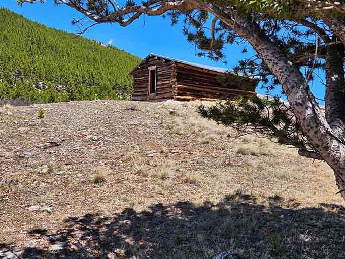 Perched on a hillside like it's contemplating whether another century of mountain weather is worth the effort.