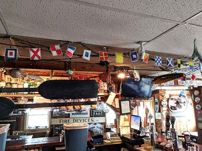 The bar area is decorated with nautical flags and quirky collectibles, like someone's cool uncle designed the whole space himself.