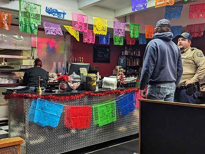 The counter area decorated with papel picado shows this kitchen takes both food and festivity seriously.