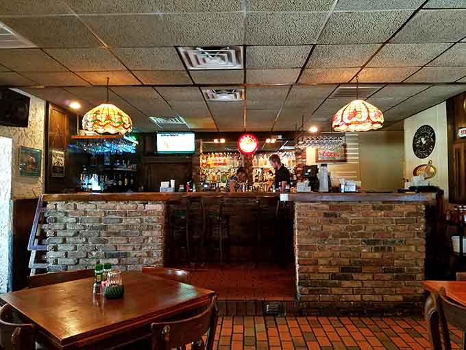 The brick-accented bar area offers the perfect spot to enjoy a drink while contemplating your steak order.