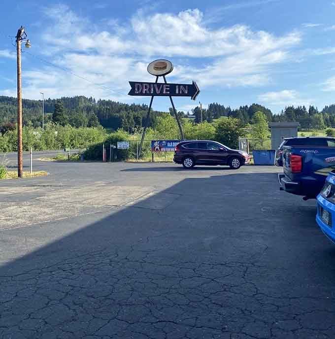 That vintage drive-in sign pointing the way to burgers, fries, and simpler times worth remembering fondly.