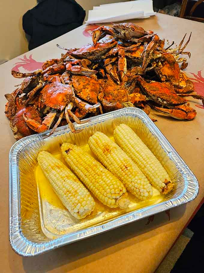 Golden corn swimming in butter alongside spice-crusted crabs, the kind of pairing that makes summer worth celebrating year-round.