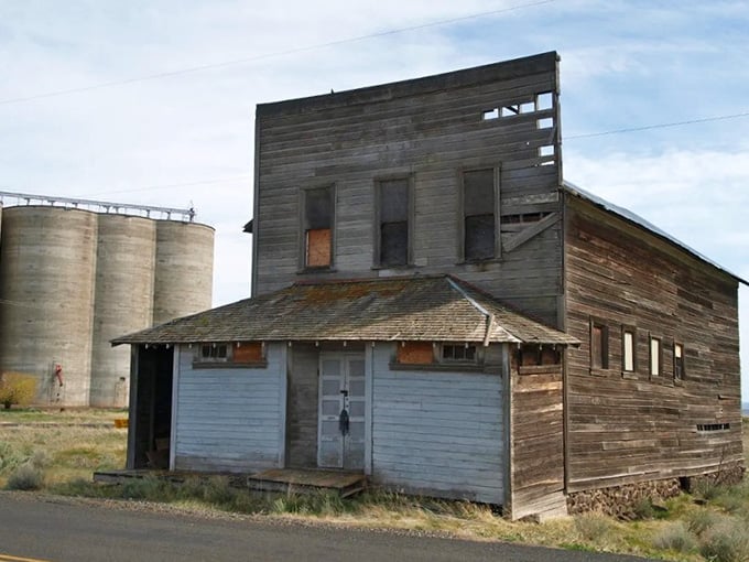 The grain silos loom behind this abandoned store like silent witnesses to Kent's busier past and quieter present.