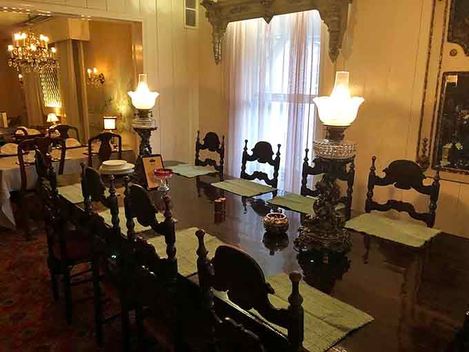 Dark wood chairs and white linens create dining rooms where conversations linger long after plates are cleared.