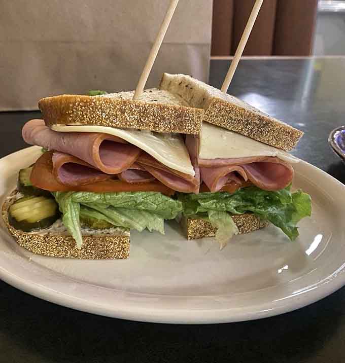 Stacked high with house-made meats on fresh rye bread, this sandwich means serious business in the best possible way.