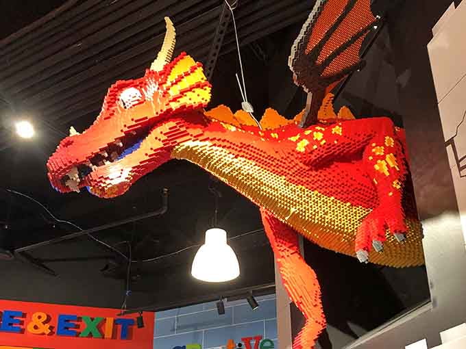 A fiery dragon soars overhead, reminding everyone that LEGO magic extends well beyond the building tables.