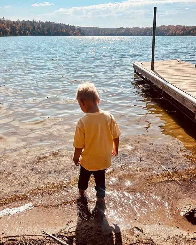 Standing at water's edge, contemplating life's big questions like whether fish actually enjoy being caught and released.