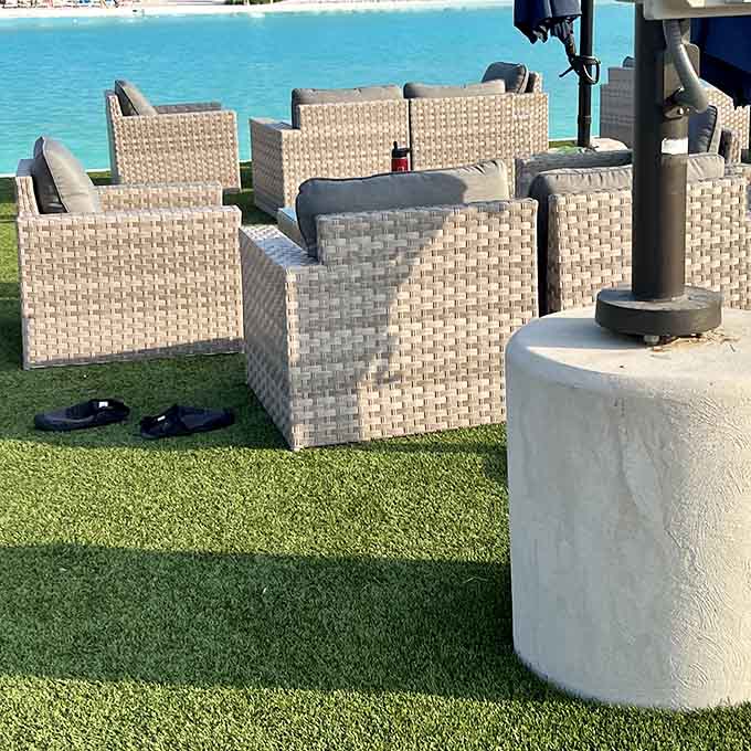 Comfortable seating on actual grass overlooking that ridiculous blue water&mdash;because sometimes you need a break from floating around paradise.