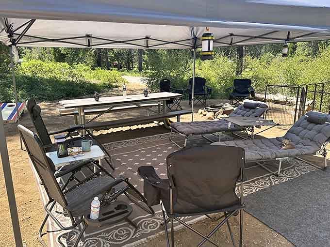 This campsite setup screams "we've mastered the art of outdoor living" with chairs, canopy, and serious relaxation vibes.