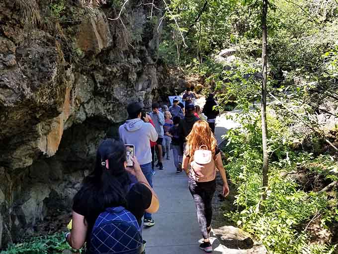 Following the crowd into the cave entrance, where summer heat gives way to that refreshing 42-degree underground chill.