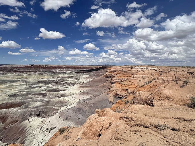 Puffy clouds float above the eroded wonderland, adding their own artistry to an already spectacular natural canvas below.