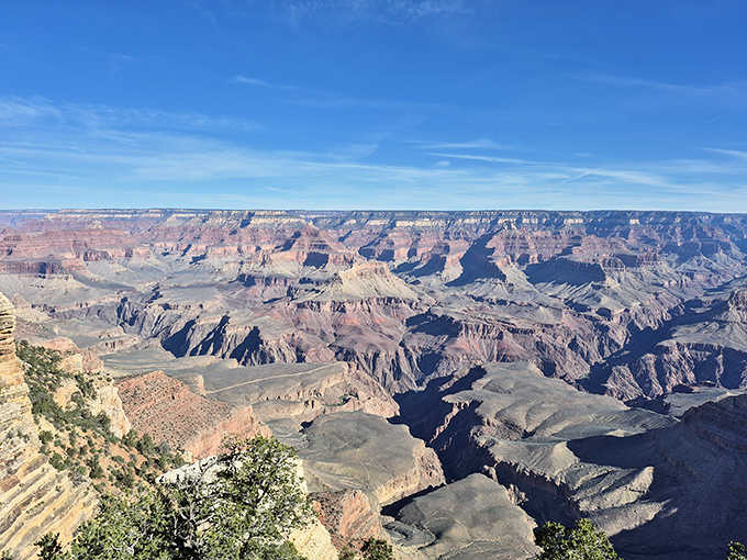 Looking up reveals nature's skylight, framing Arizona blue against fiery red stone in perfect composition.