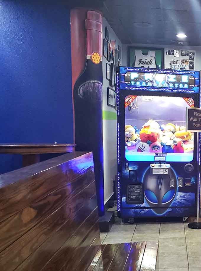 Because sometimes you need a claw machine to test your skills between bites of pizza and wings.
