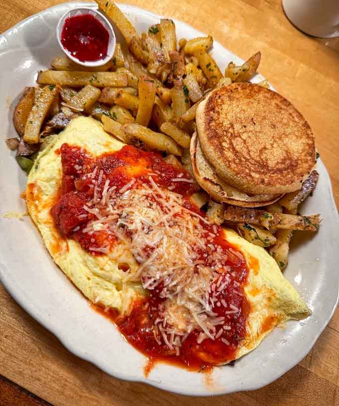 That omelette with marinara and cheese looks like Italian cuisine crashed a breakfast party and everyone's thrilled about it.