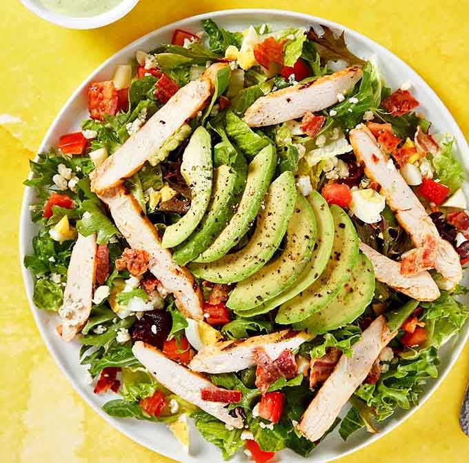 This isn't your sad desk salad, it's a colorful composition of fresh ingredients topped with perfectly grilled chicken and avocado.