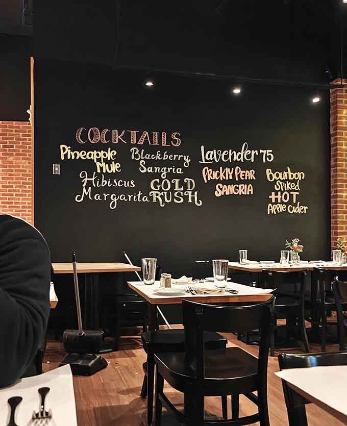 Brick walls, warm lighting, and communal seating create an atmosphere where strangers become friends over shared steak enthusiasm.