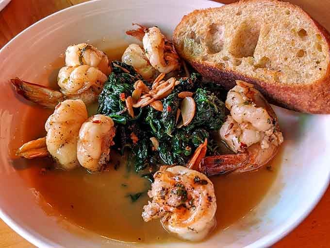 Garlic shrimp swimming in butter with crusty bread for mopping, this is how seafood should always be.